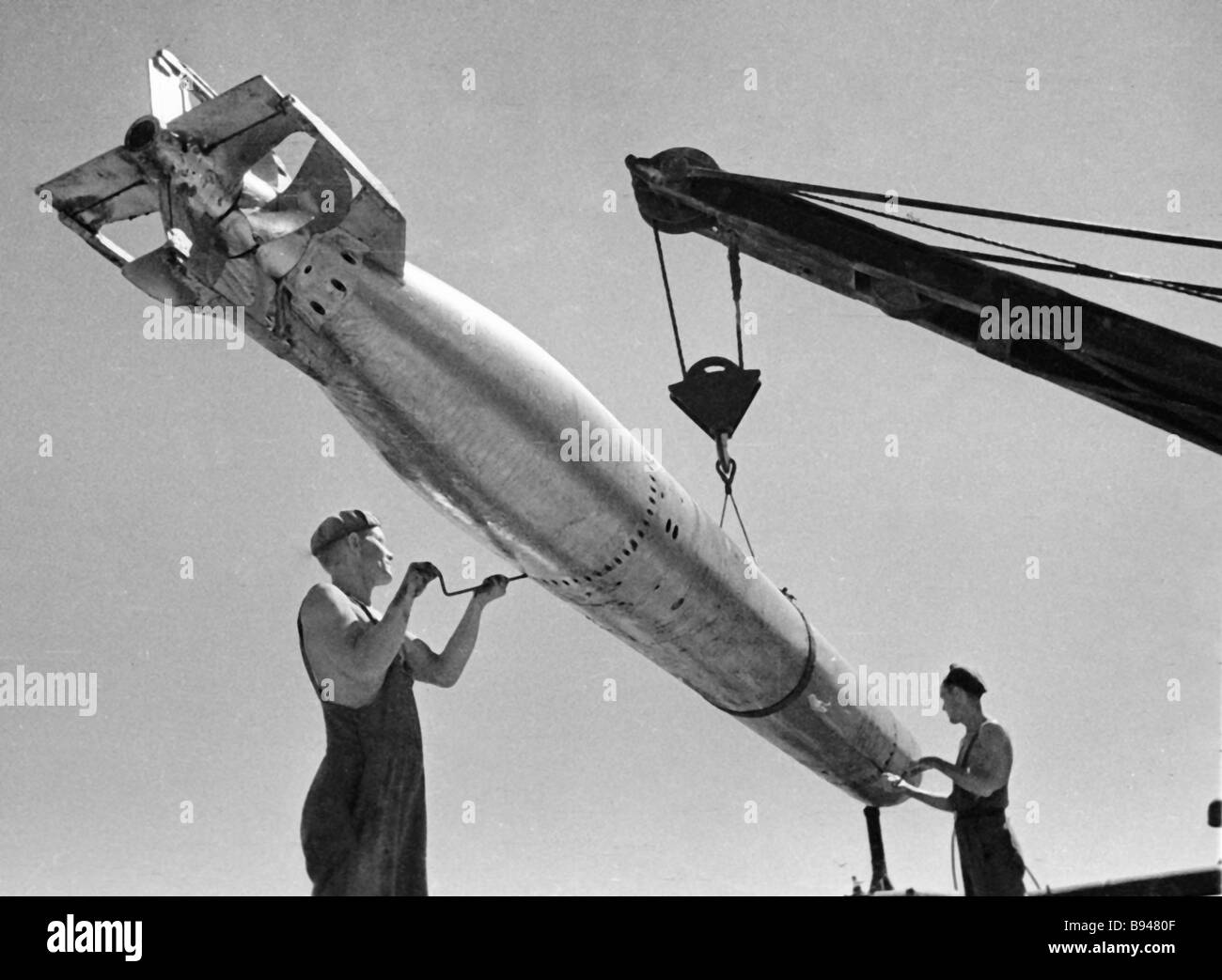 Loading torpedo into the submarine before leaving on a combat mission ...
