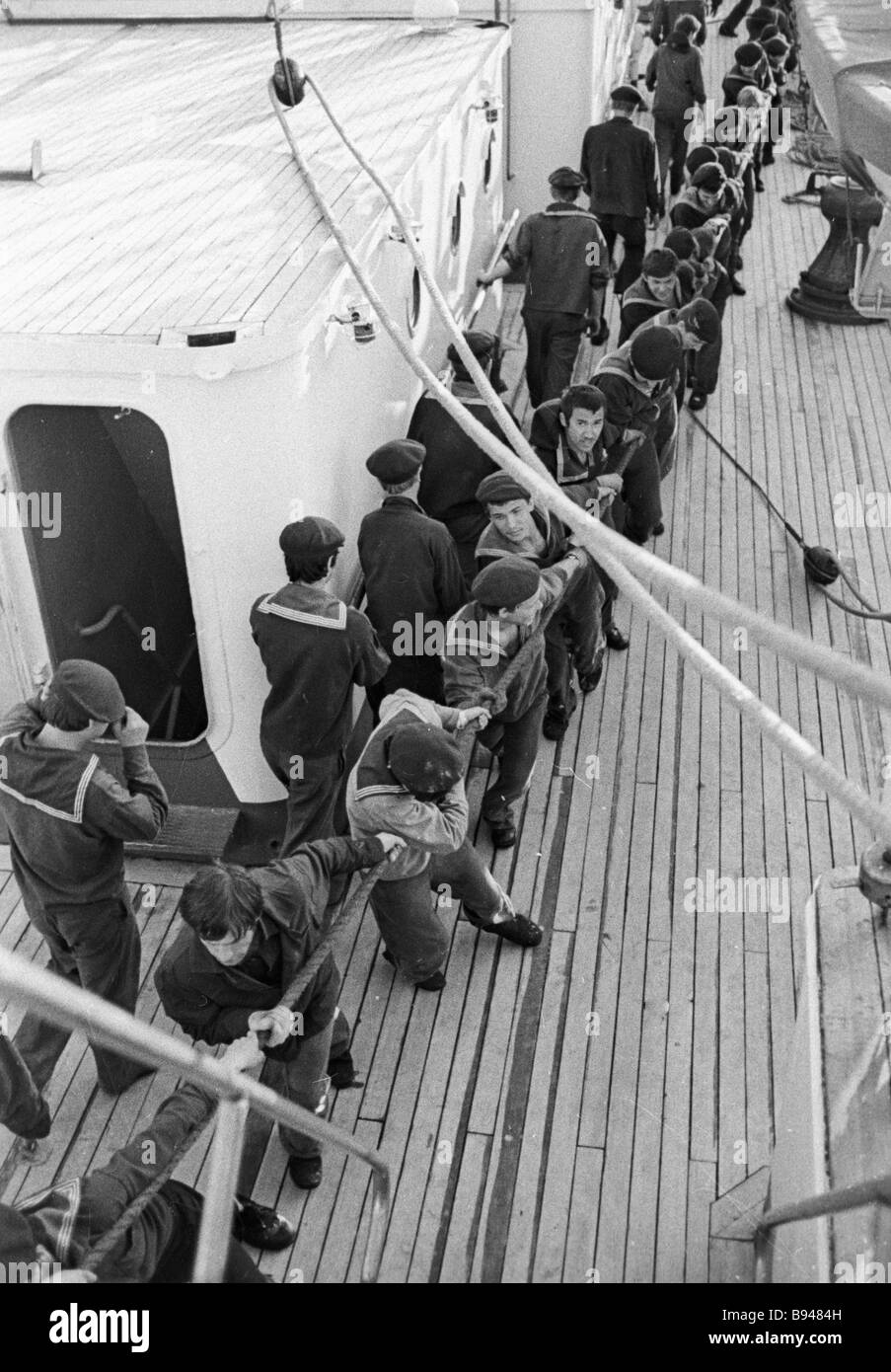 Cadets of the Sedov four mast sailing bark pulling ropes to set the ...