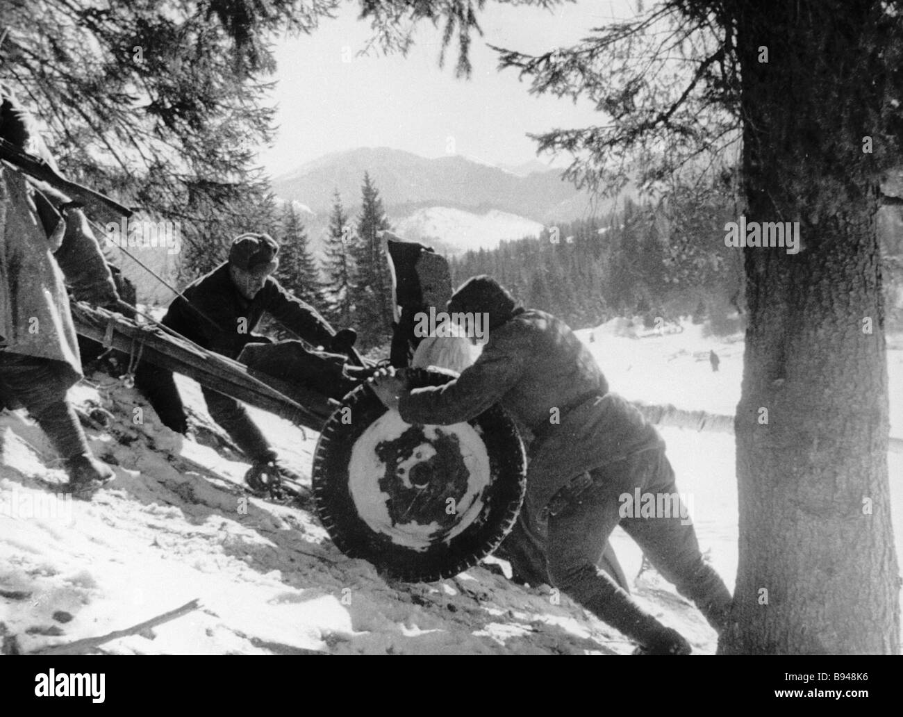 Soviet artillery men lifting their gun to a fire position in the ...