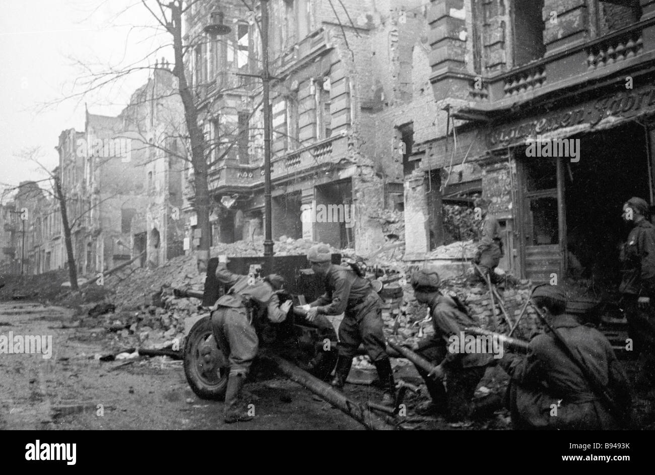 Soviet artillery men firing on Hitlerites on a Berlin street during ...