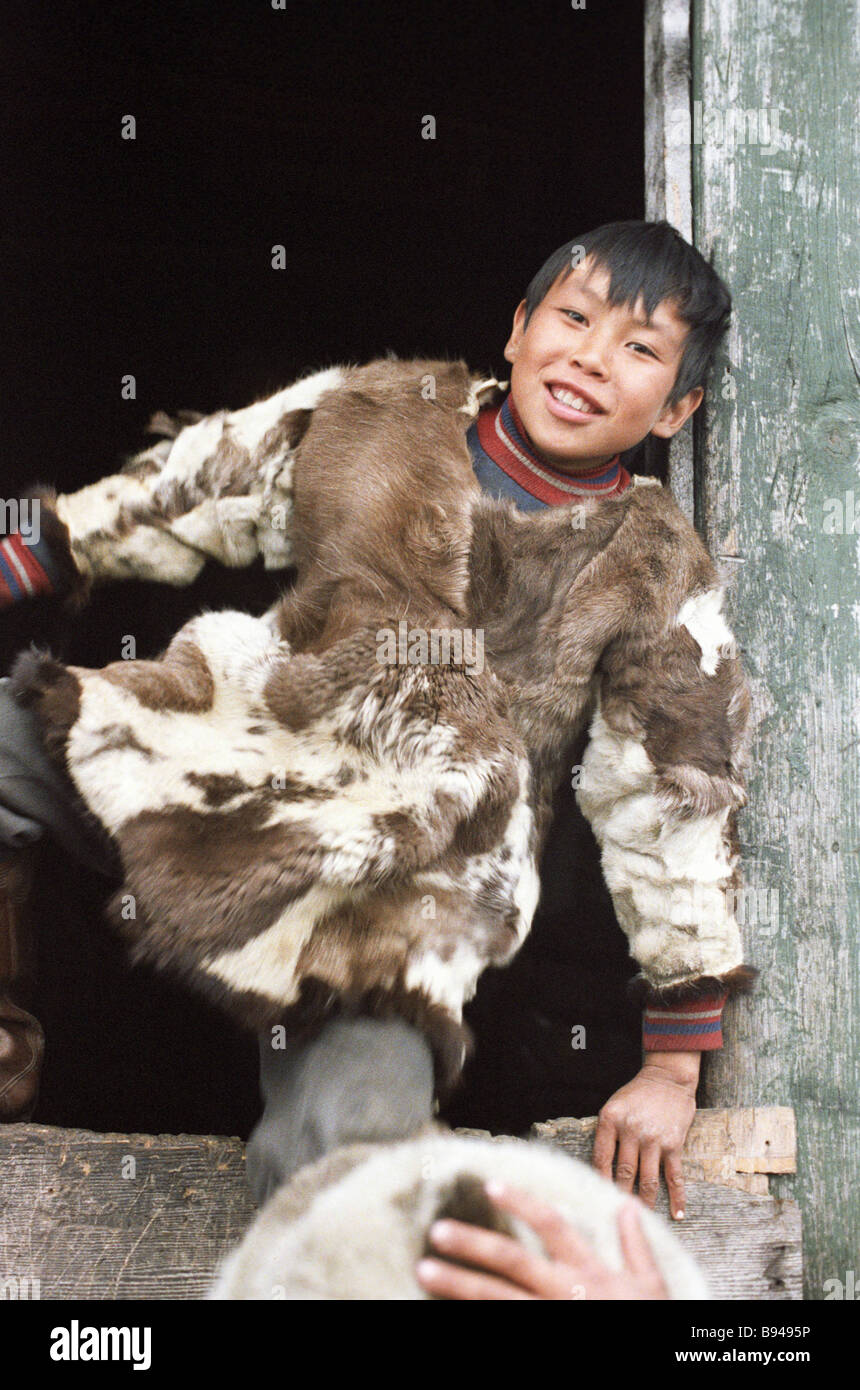 A little Eskimo boy wearing a deerskin coat Stock Photo - Alamy