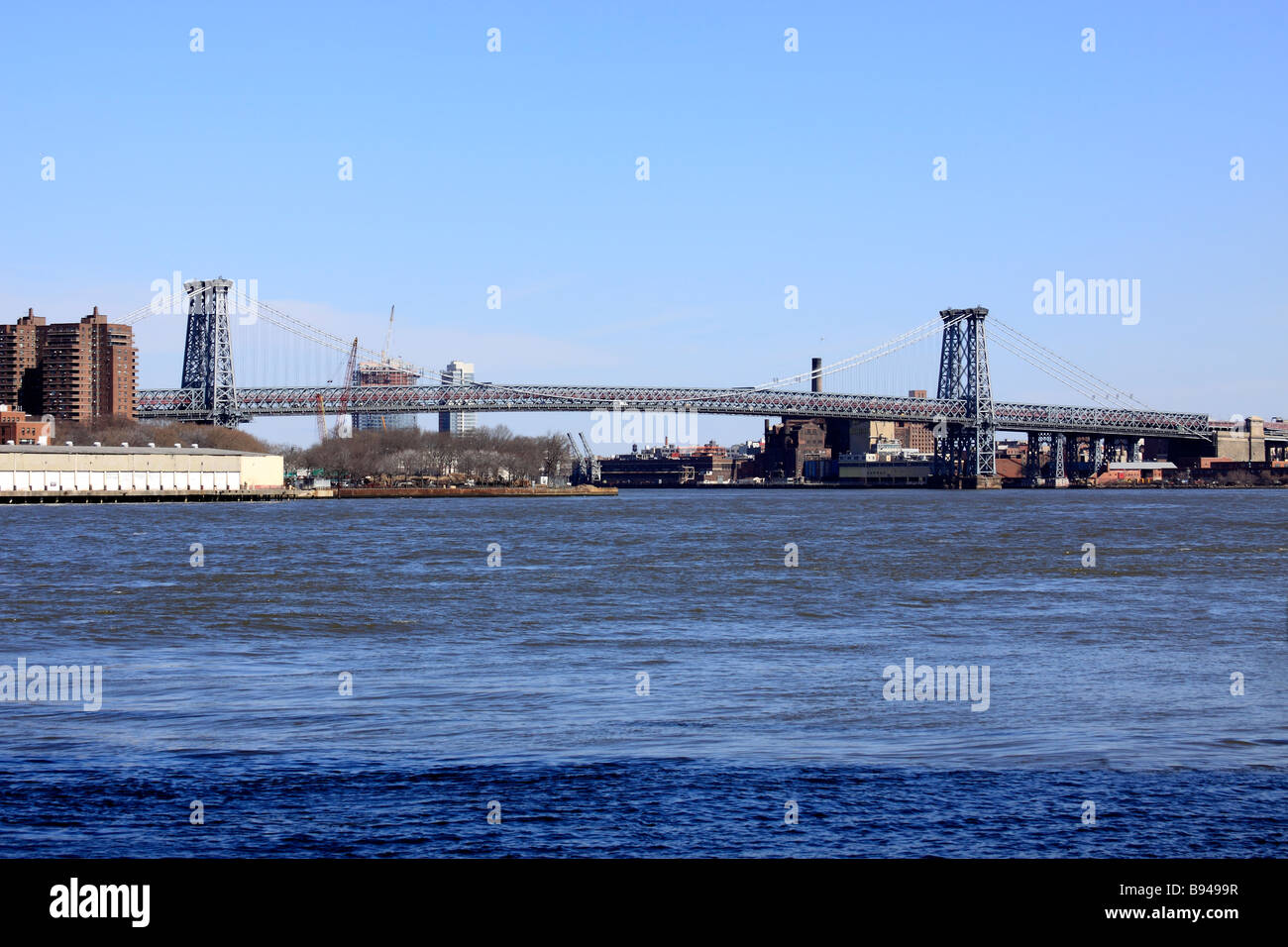 The Williamsburg Bridge across the East River, connecting Manhattan and ...