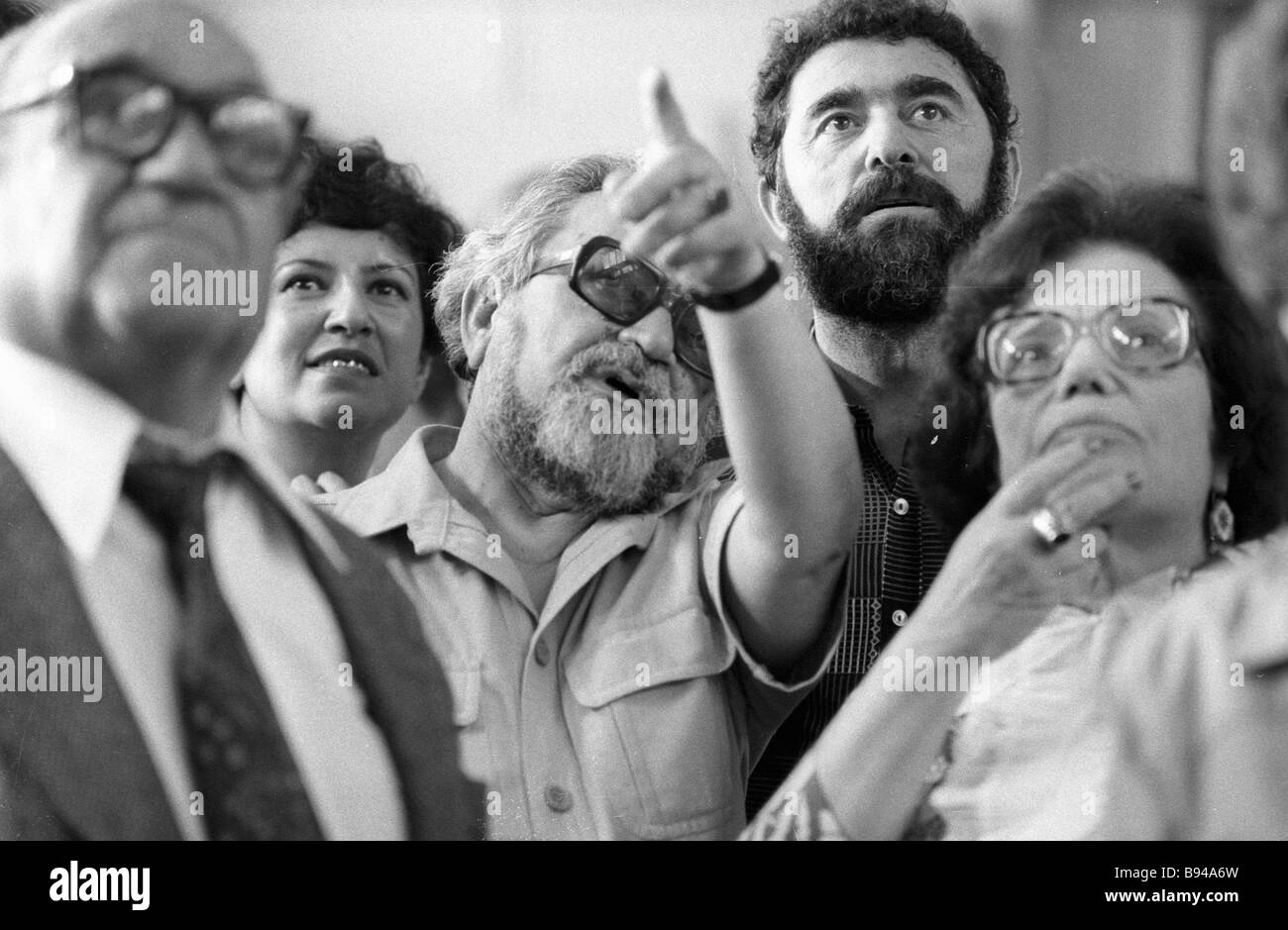 Armenian poet Gevorg Emin 3rd left watching gobelins at the exhibition ...