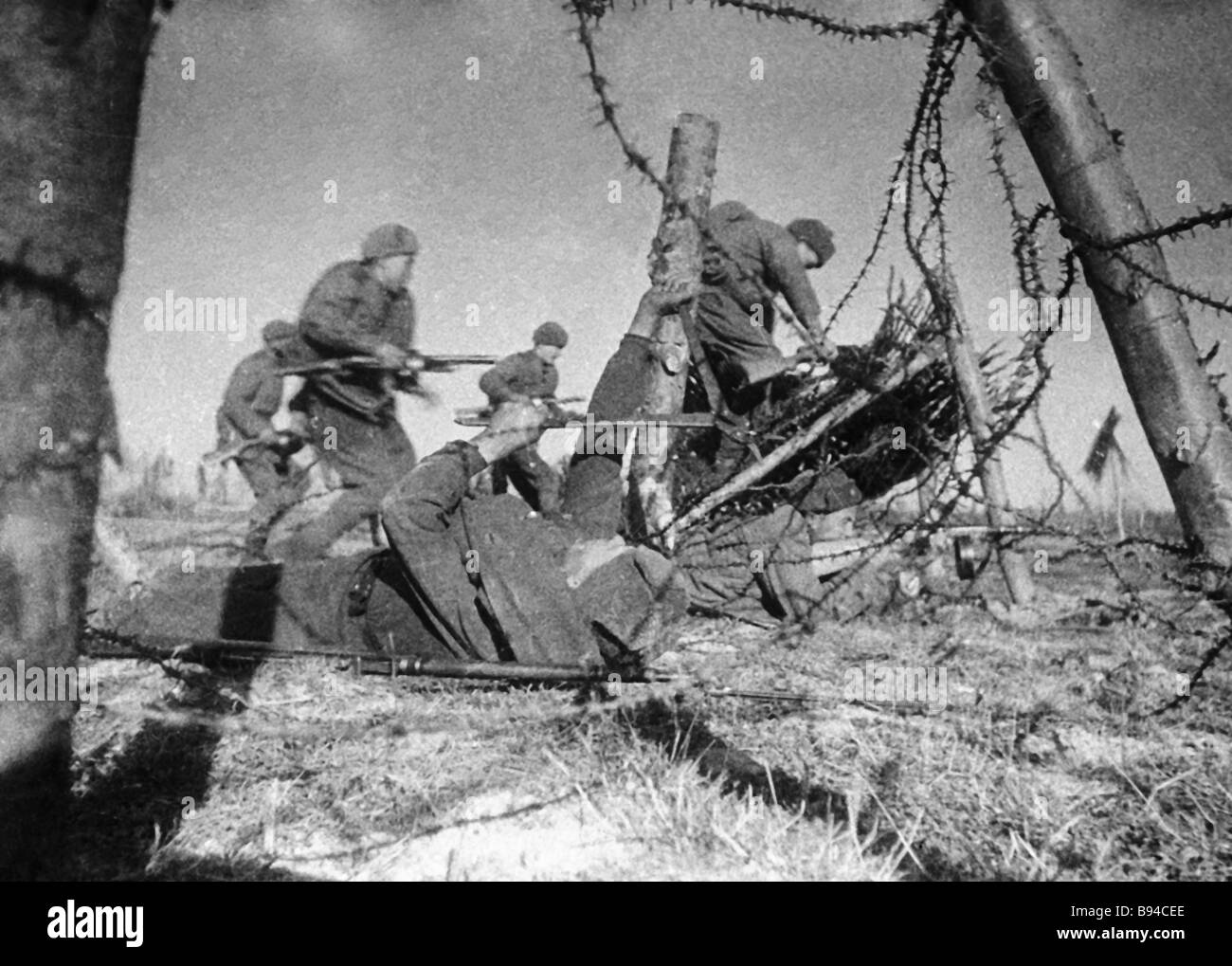 Soviet infantrymen and combat engineers surmounting barbed wire ...