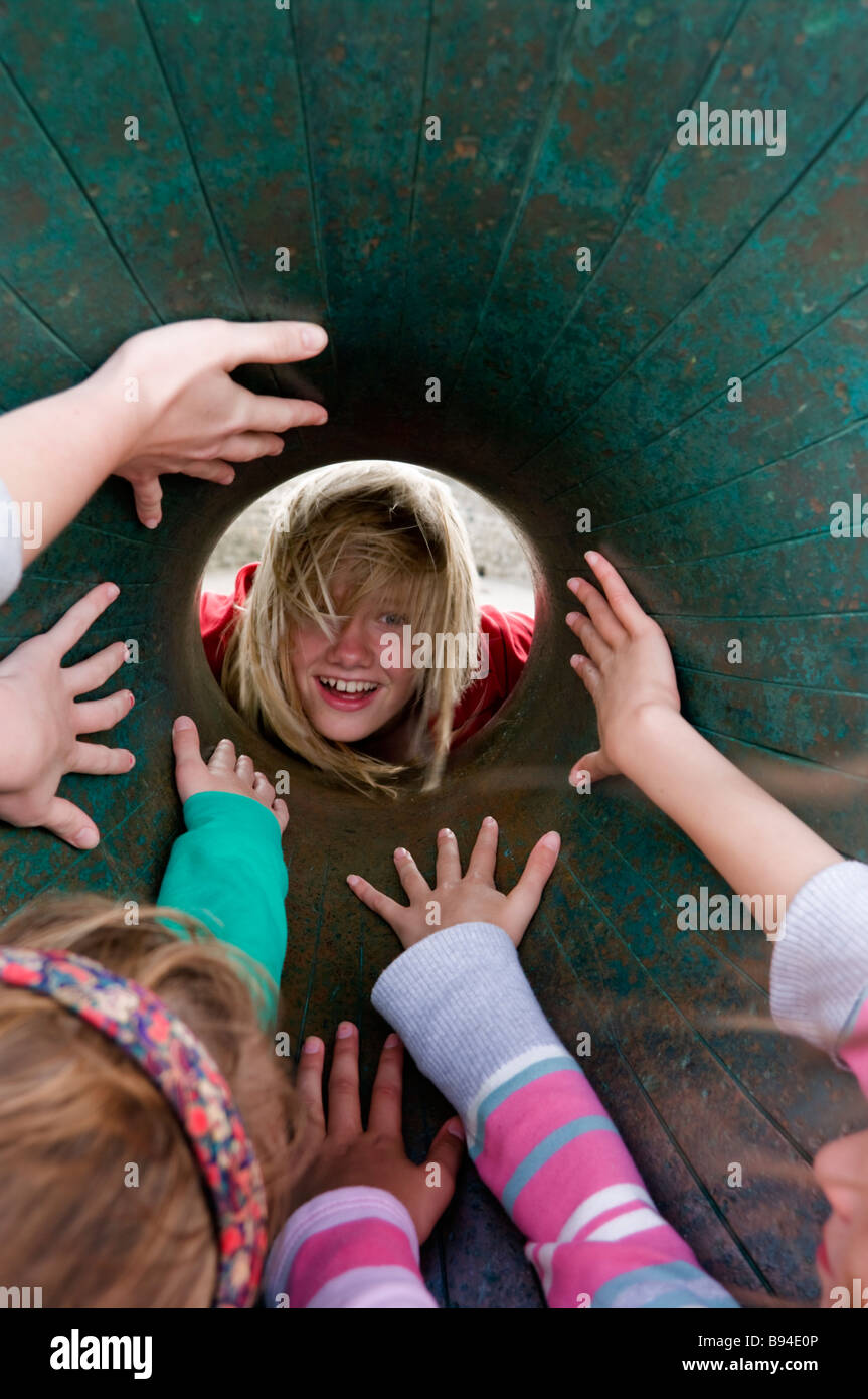 children feeding into donut Stock Photo - Alamy