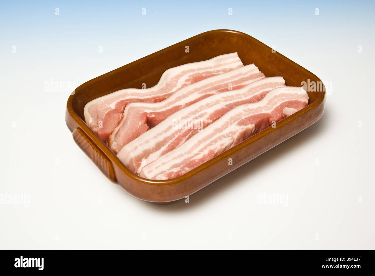 belly pork meat on a blue studio background Stock Photo - Alamy