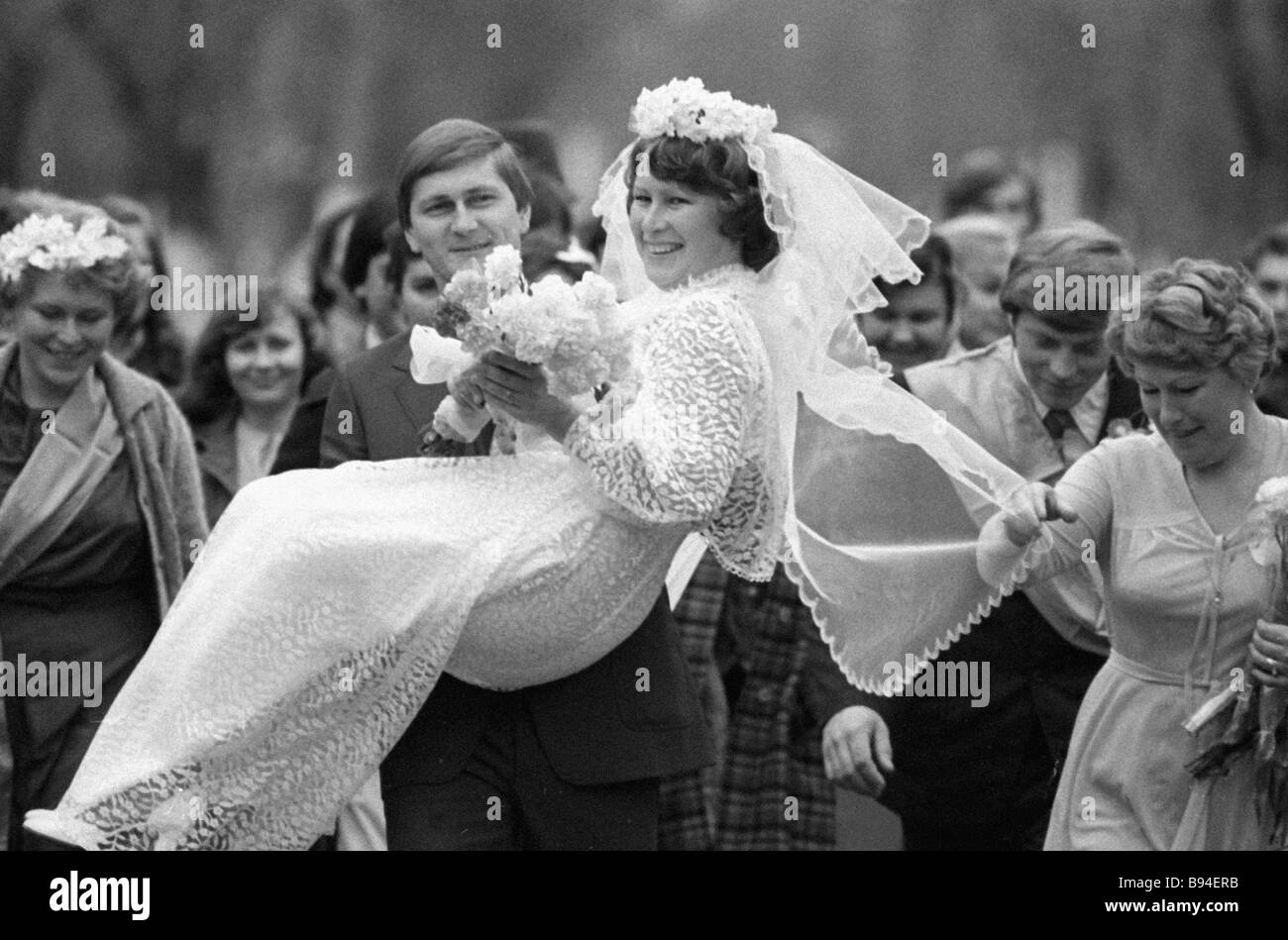 Bridegroom carries bride Stock Photo - Alamy