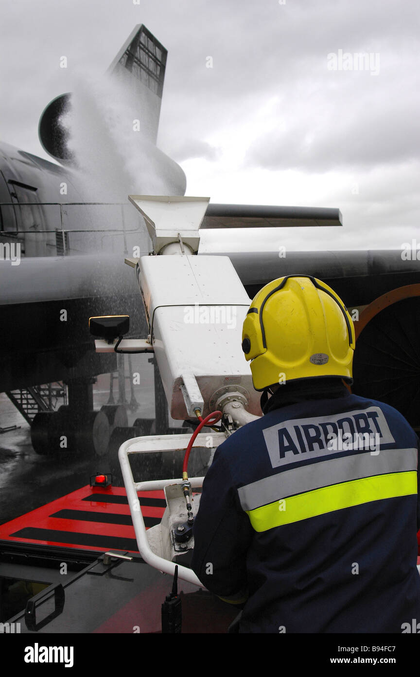 An airport firefighter practising on an aircraft simulator Stock Photo ...