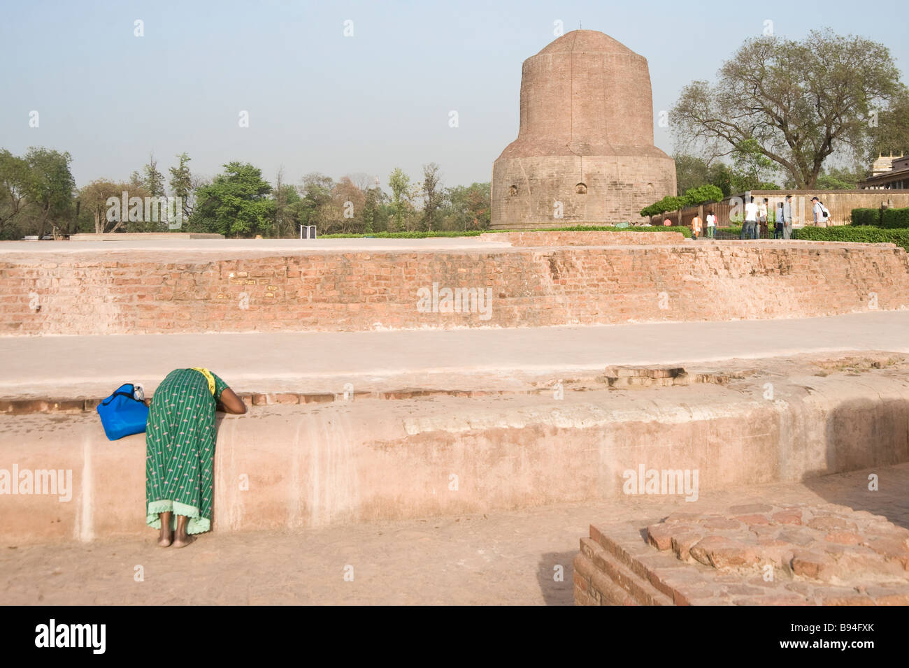 Praying Devotee in front of the Dhamekh stupa Isipatana deer park ...