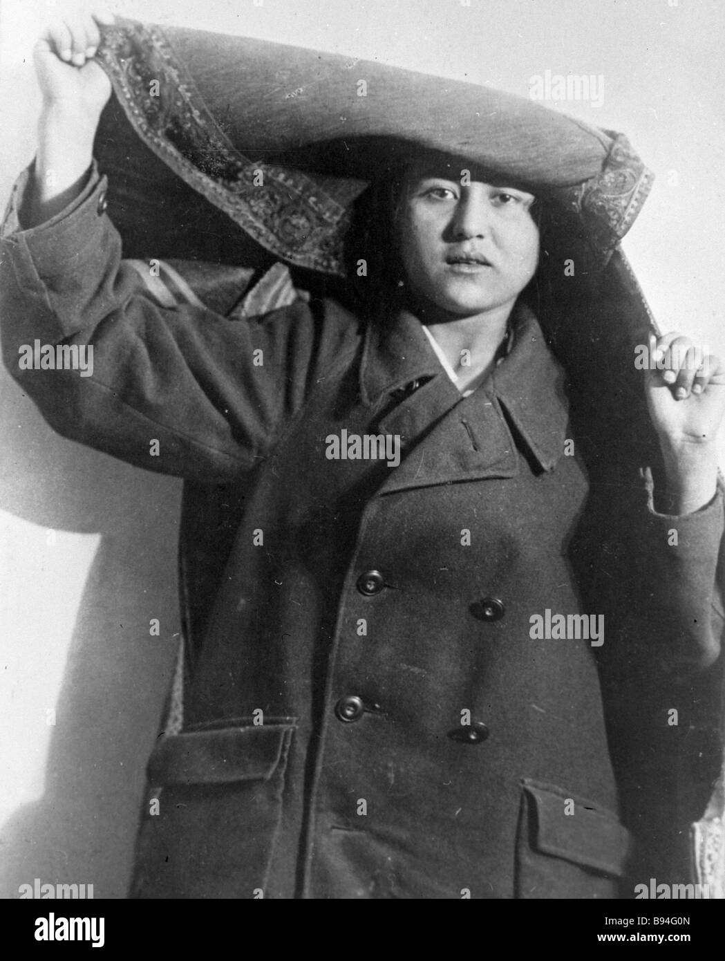 An Uzbek woman taking off a paranja Stock Photo - Alamy