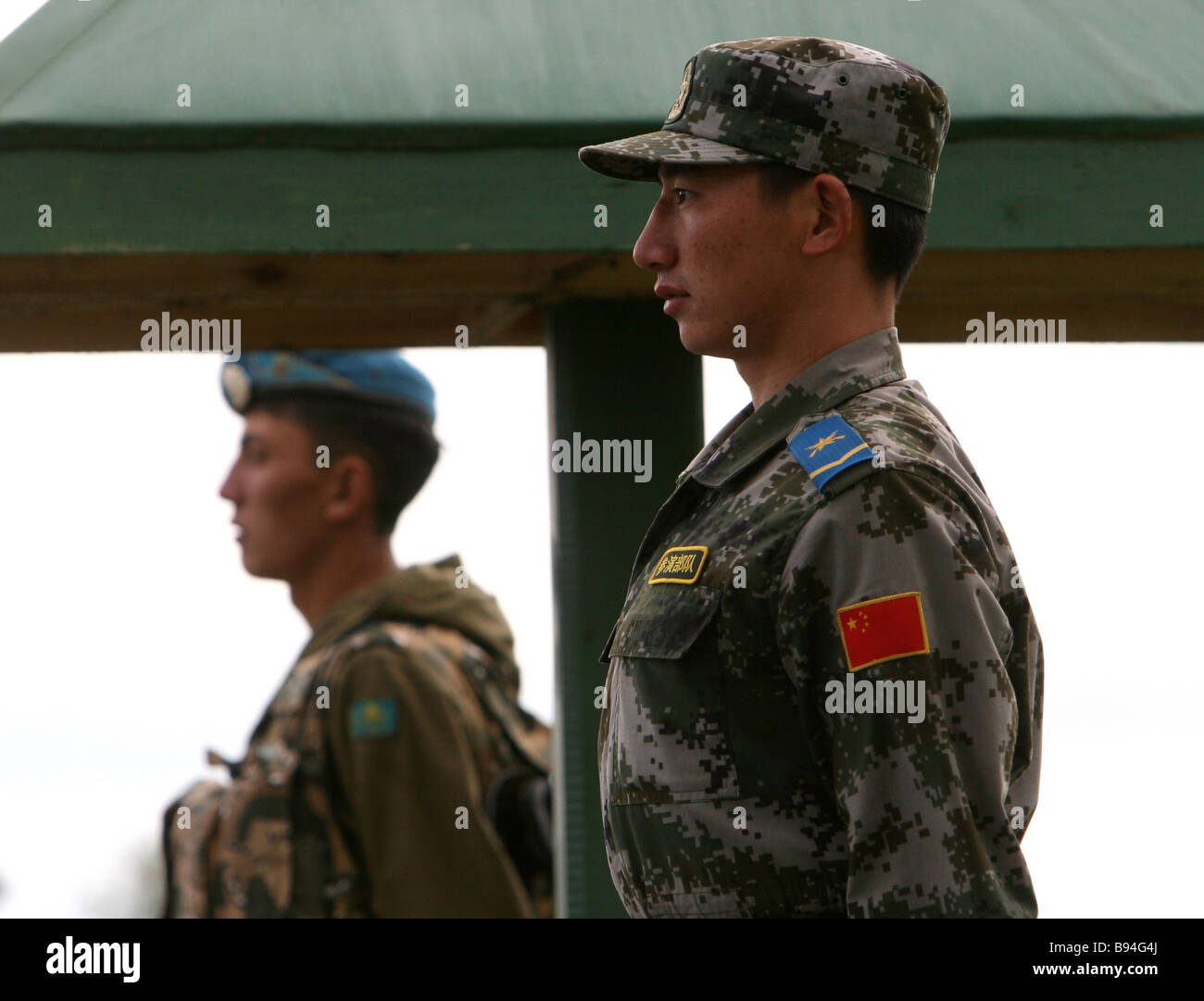 A soldier of the Chinese People s Liberation Army right and a Kazakh ...