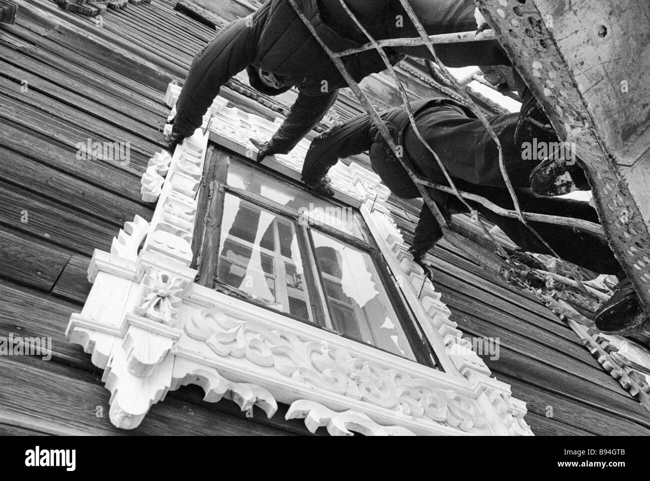 Carpenters renovate the window cases of a wooden house Stock Photo - Alamy
