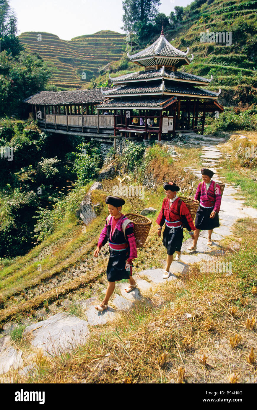 Red Yao nationality women pass Longsheng County wind and rain bridge ...