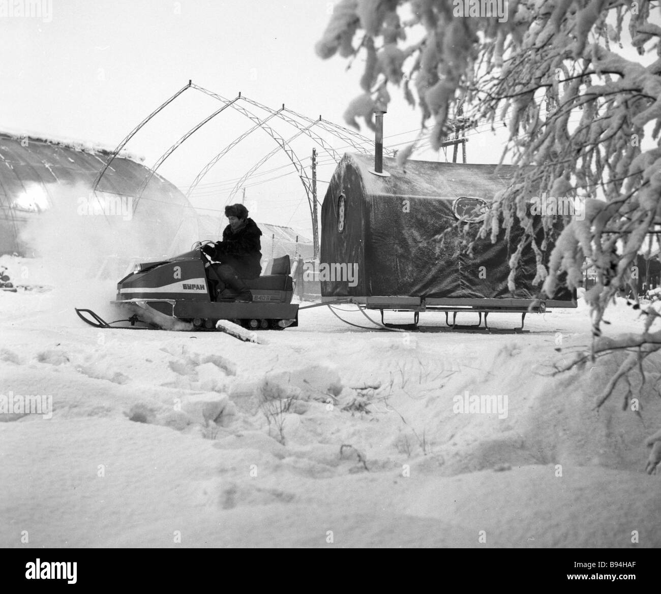 Buran snowmobile transporting the tent house for deer breeders Stock ...