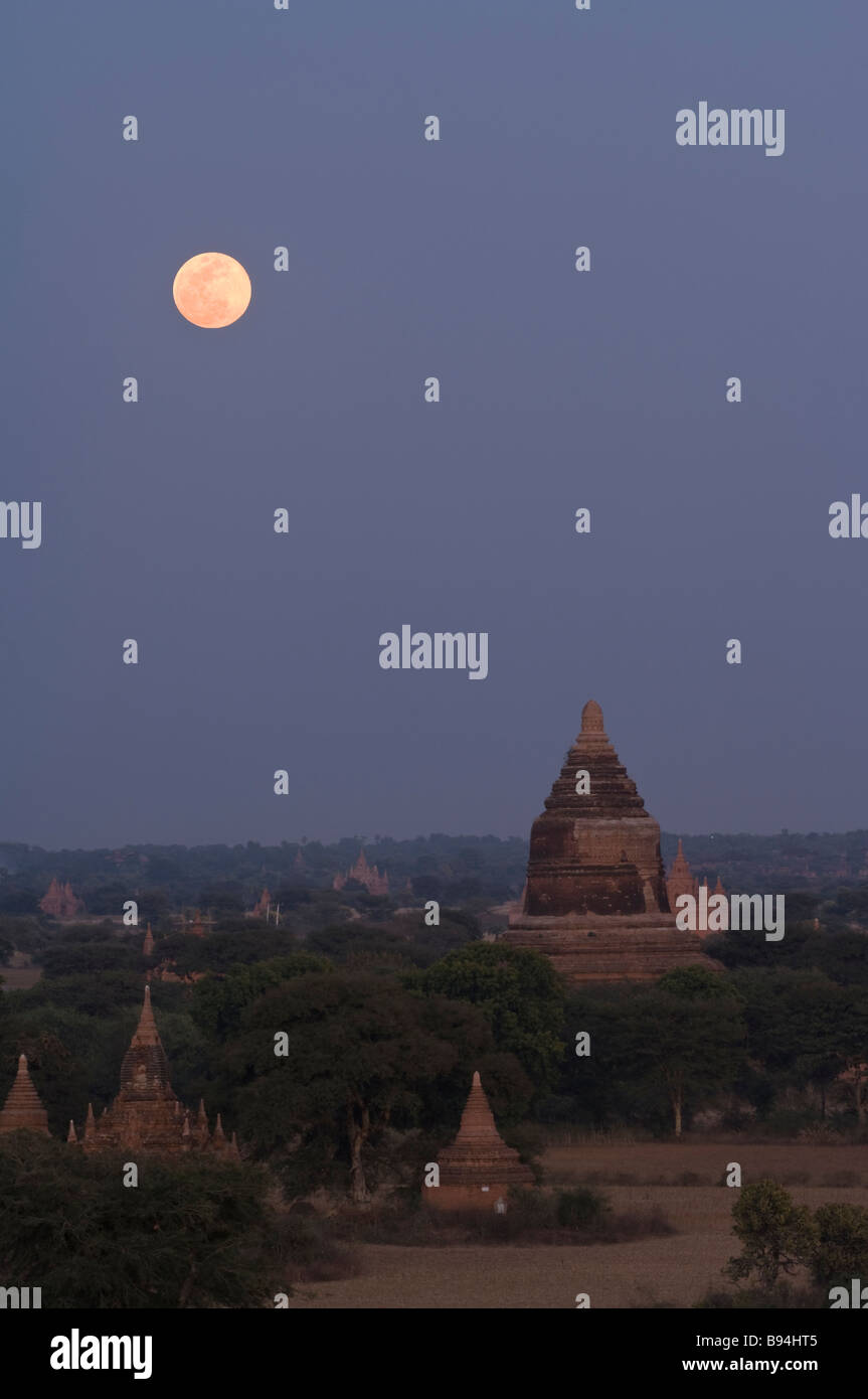 Full Moon setting over Bagan Stock Photo - Alamy