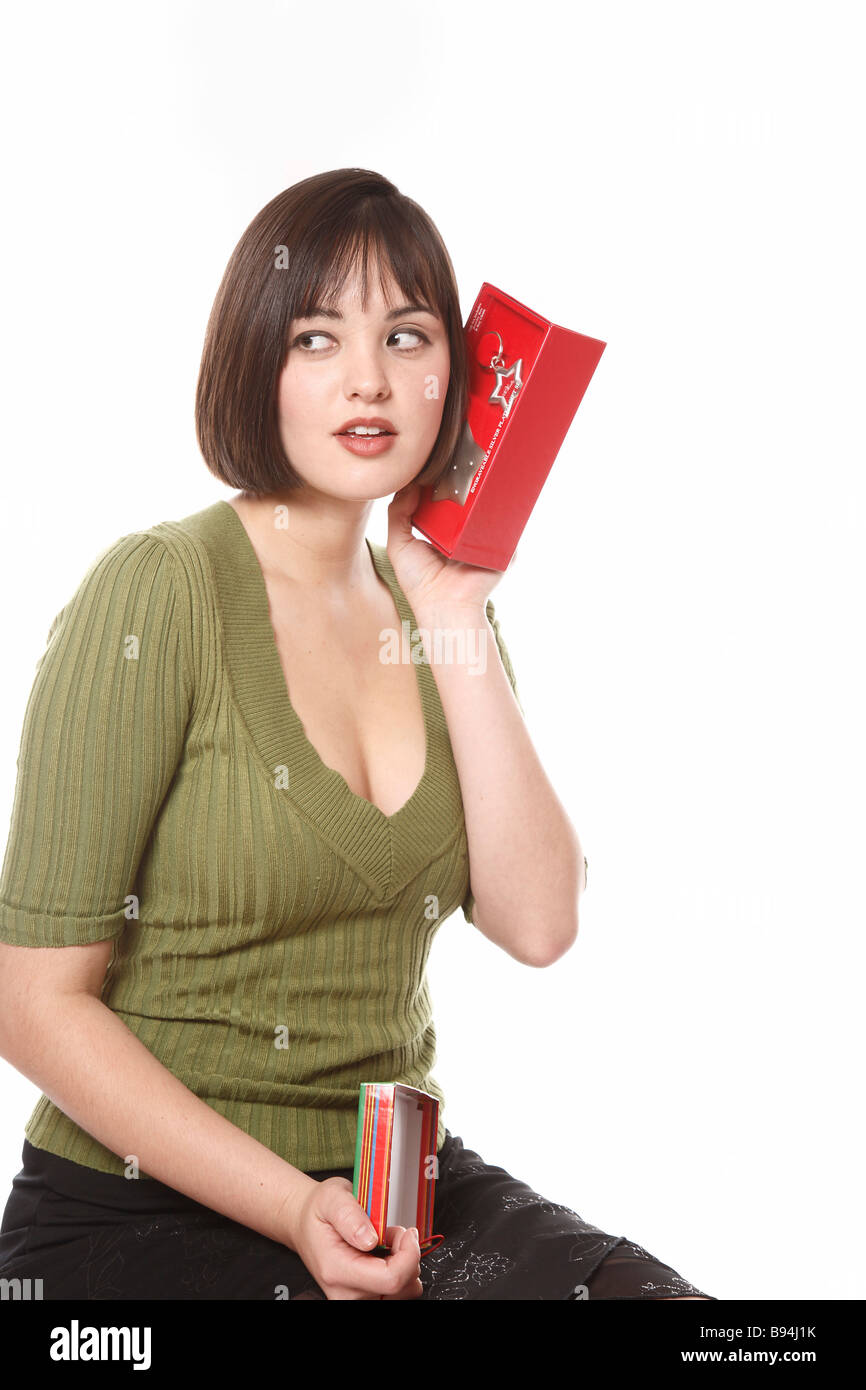 Woman shaking gift box Stock Photo - Alamy