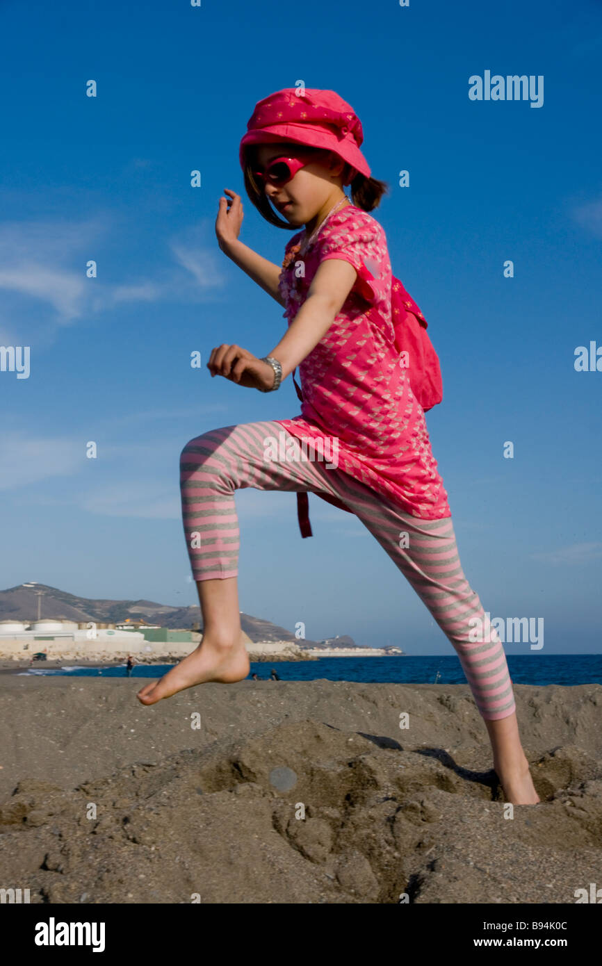 girl child running along seaside bank of sand Stock Photo - Alamy