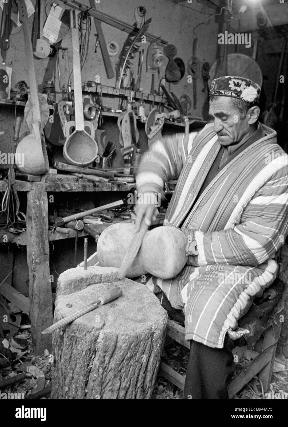 A Tajik teacher makes folk musical instruments in his spare time Stock ...