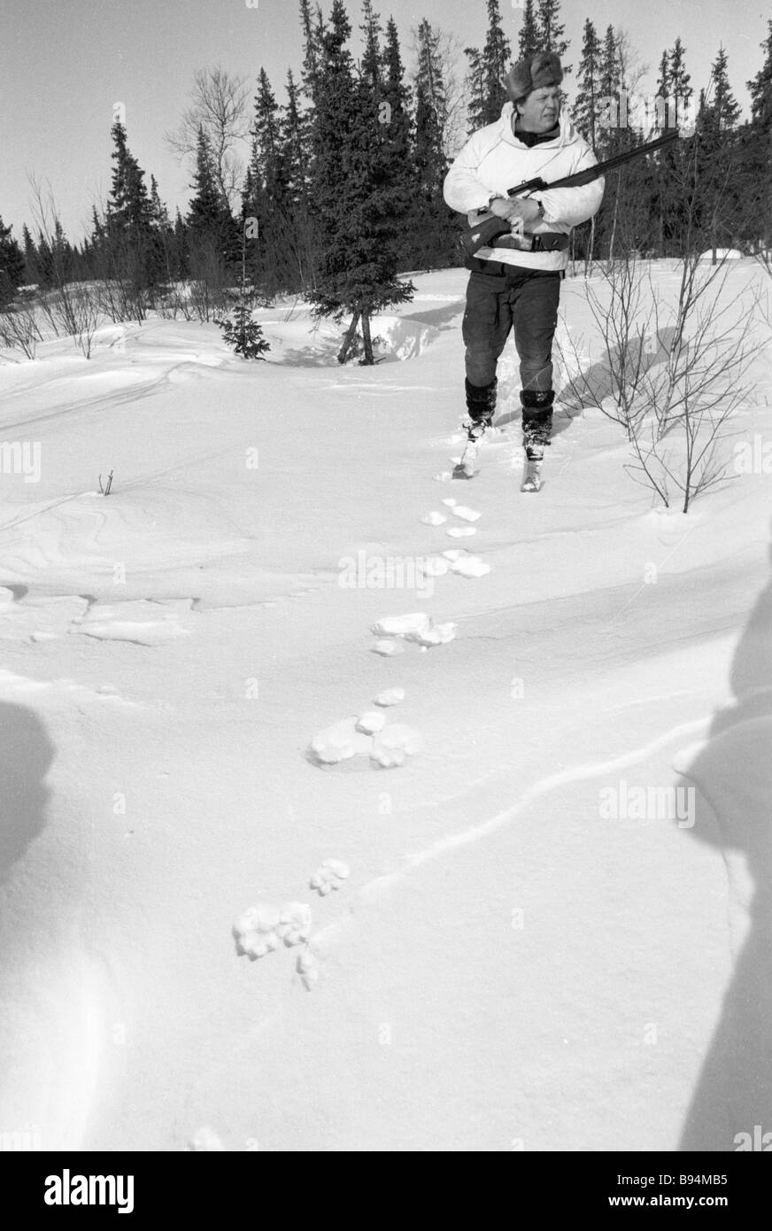 A hunter following the hare tracks Stock Photo - Alamy