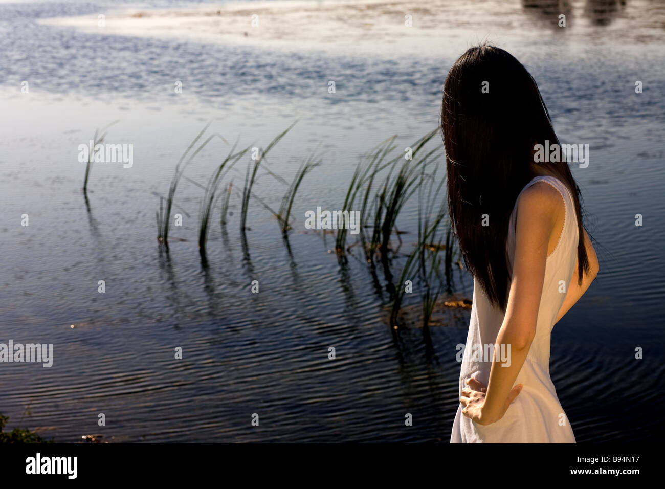A Beautiful Young Woman Gazing over the water Stock Photo - Alamy