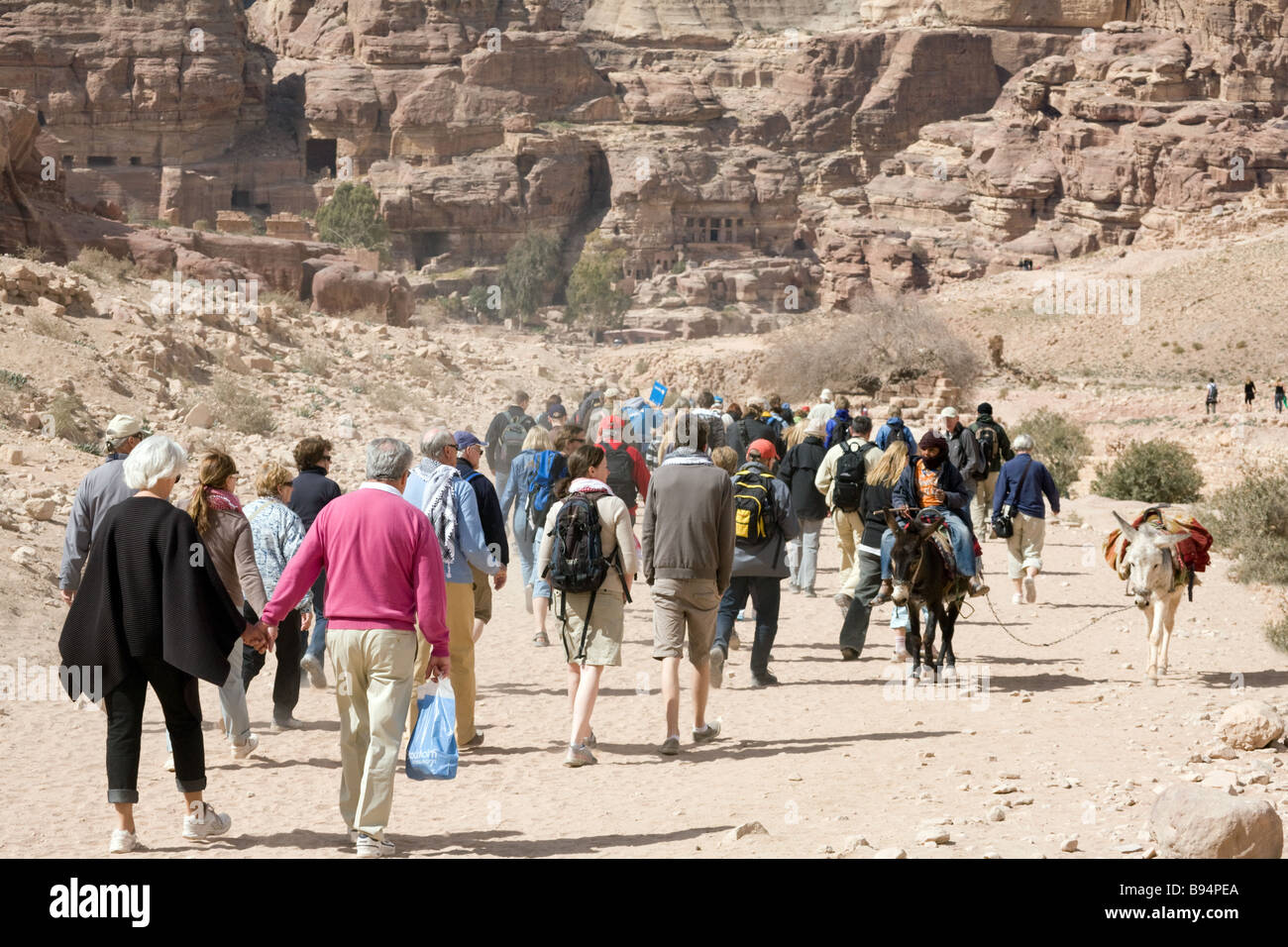 A large group crowd of western tourists walking in Petra, Jordan ...