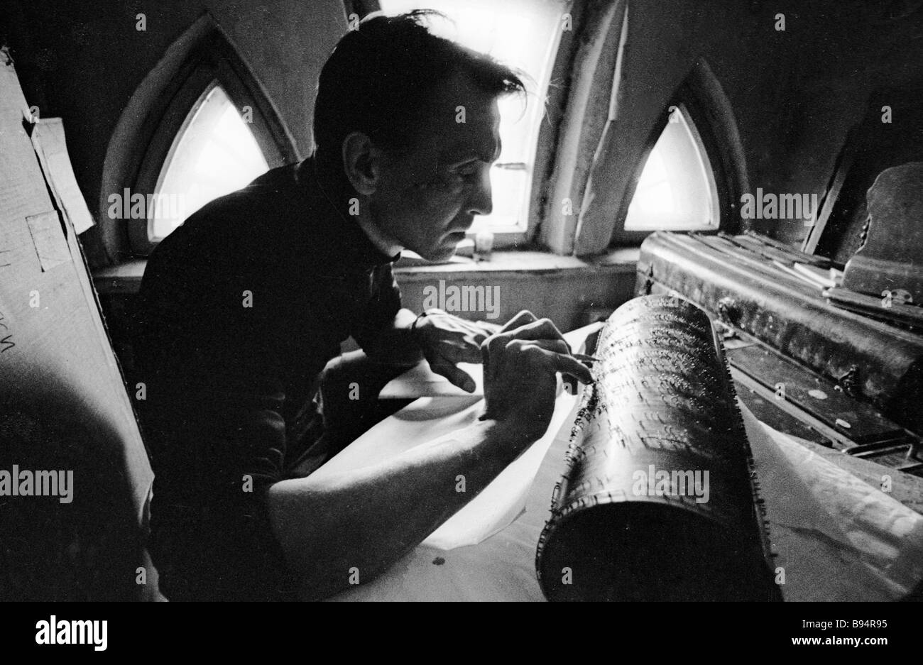 A restorer of old musical instruments restores a jukebox cylinder ...