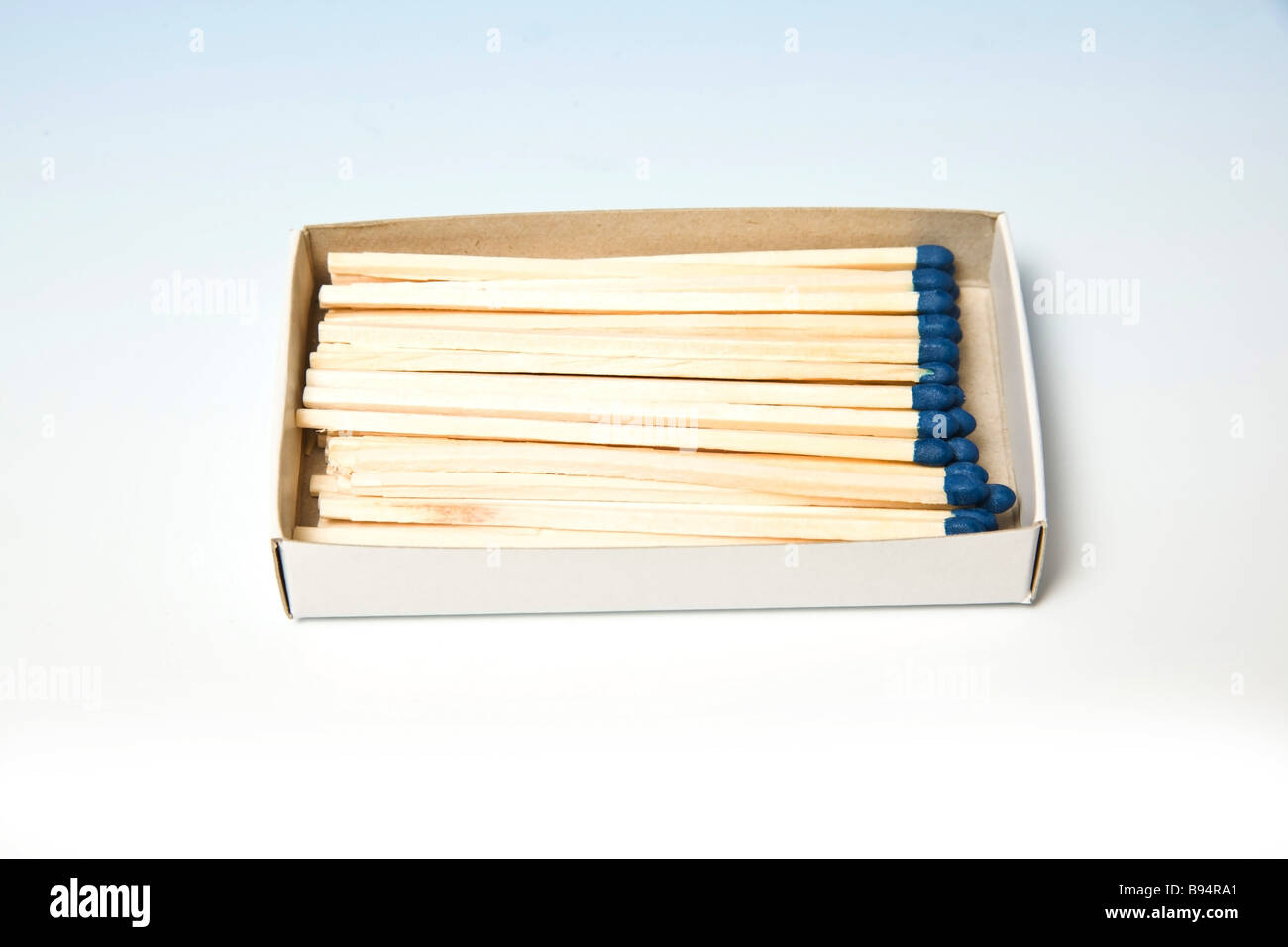 Box of matches on a graduated blue studio background Stock Photo - Alamy