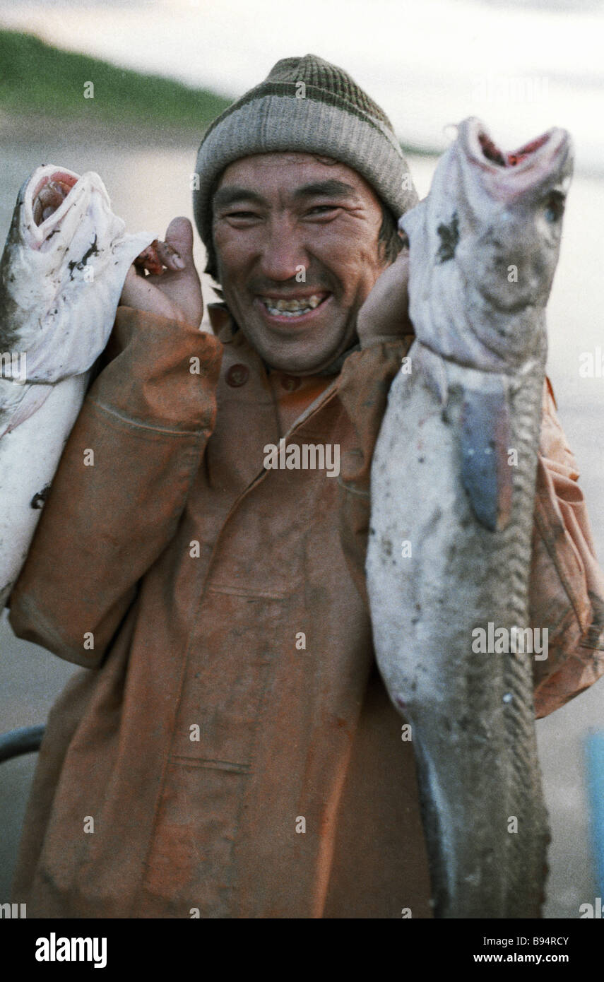 A fisherman displaying his catch Stock Photo - Alamy