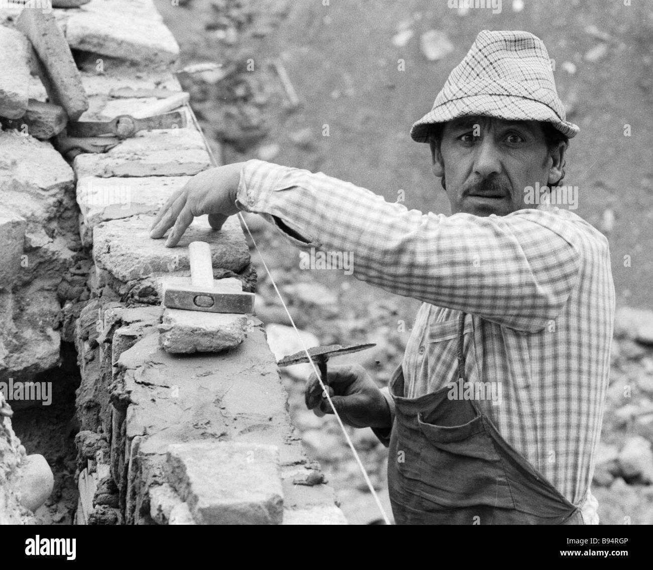 A bricklayer restoring a 16th century multicolor bath in Tbilisi ...