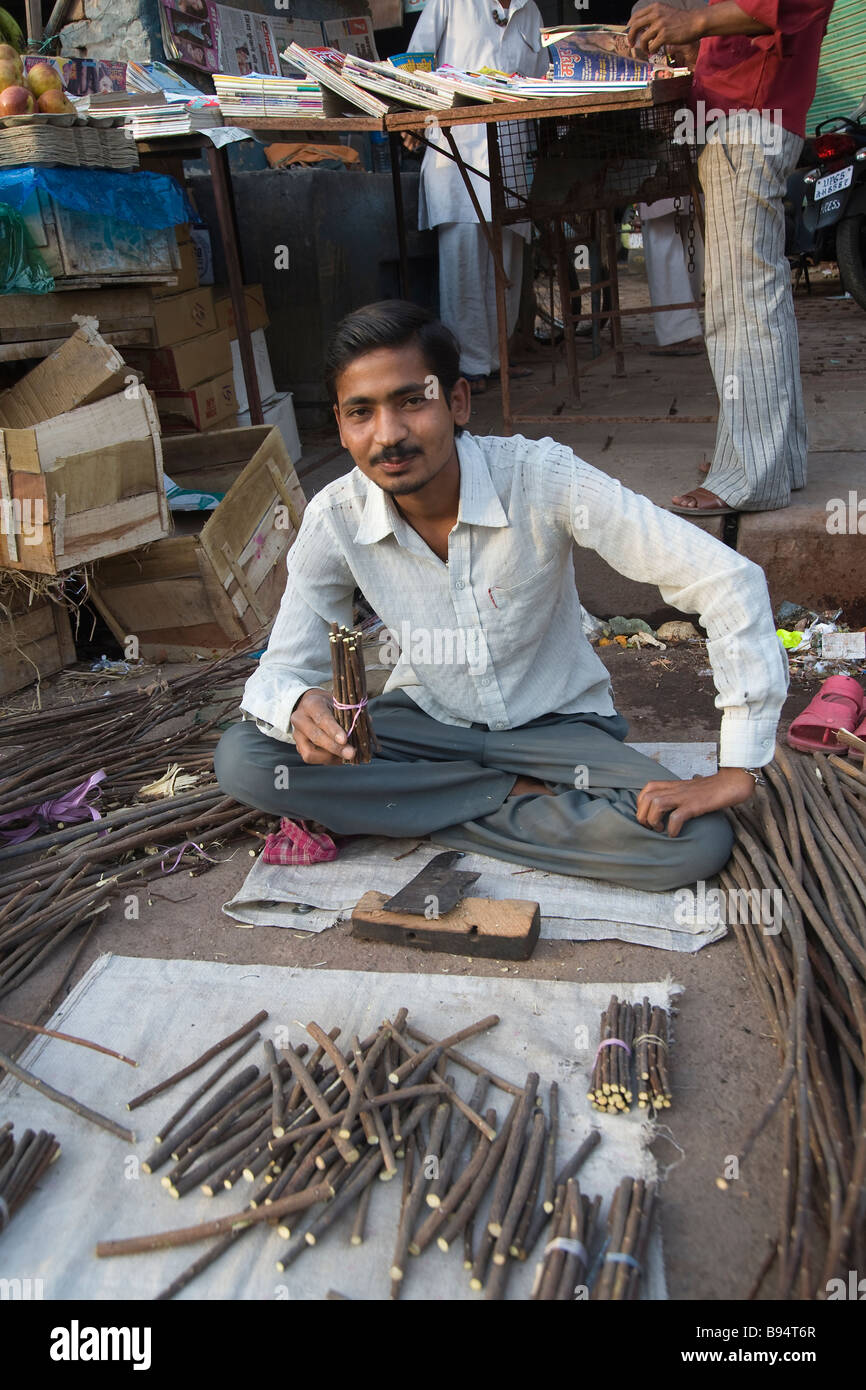 Indian man selling wood sticks used as toothbrush Old city of Varanasi ...