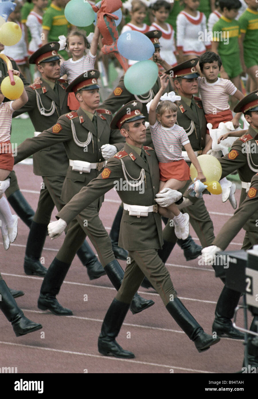 Parade participants with children on their arms Stock Photo - Alamy