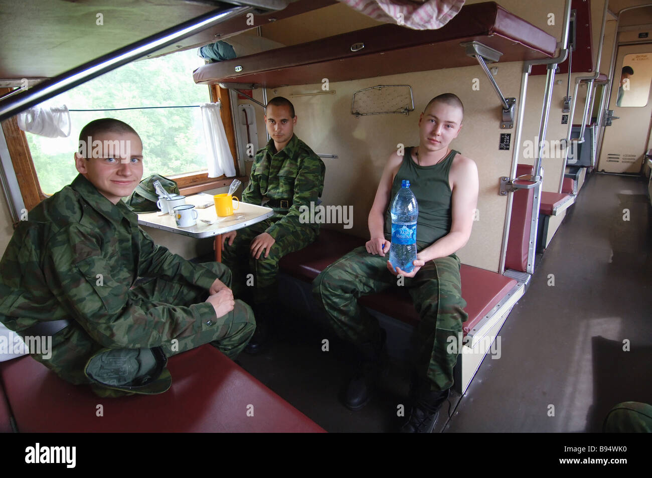 Settling in a compartment as an army draftee train departs from the ...