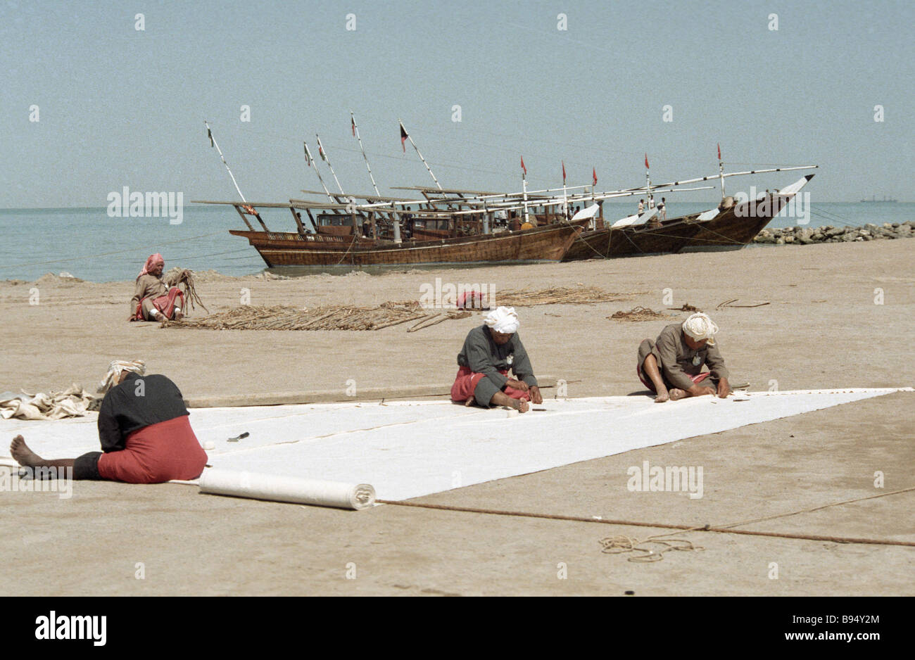 Workers making a sail for dou a national Kuwait boat Stock Photo - Alamy