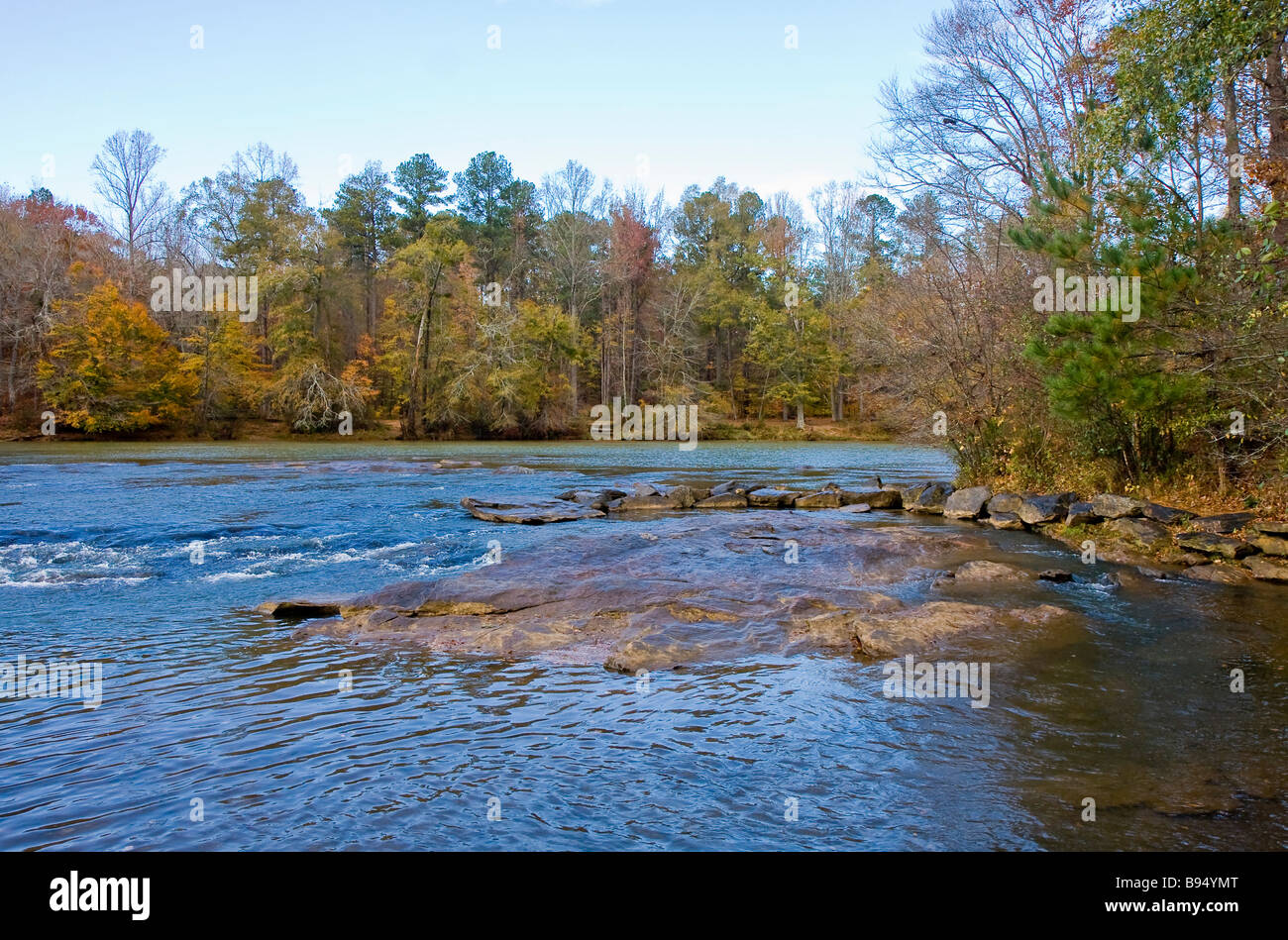 A river in the fall reflecting the blue sky Stock Photo - Alamy