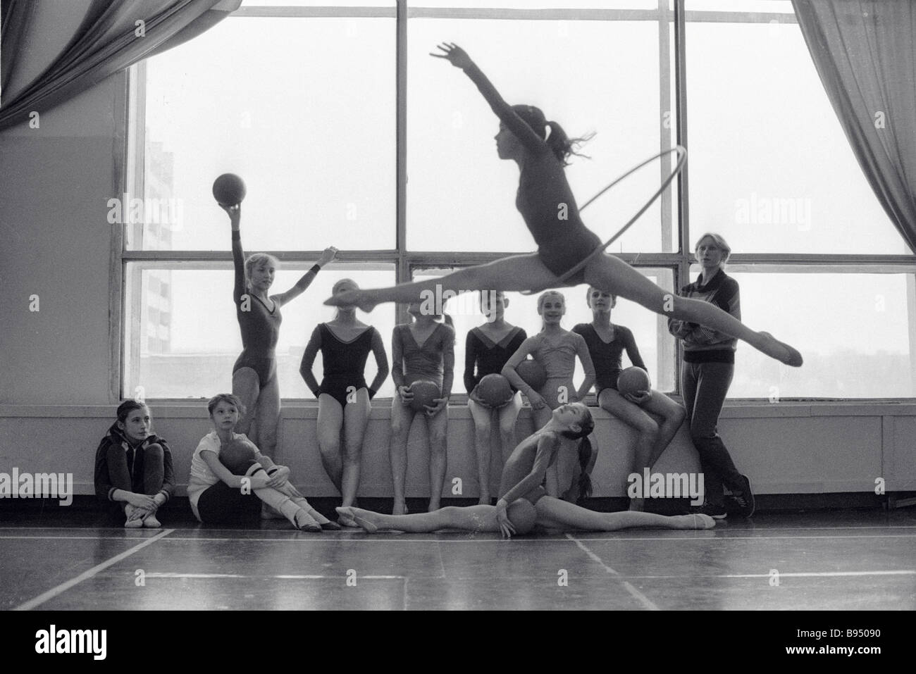 A girl from the rhythmic gymnastics school for children does a hoop ...