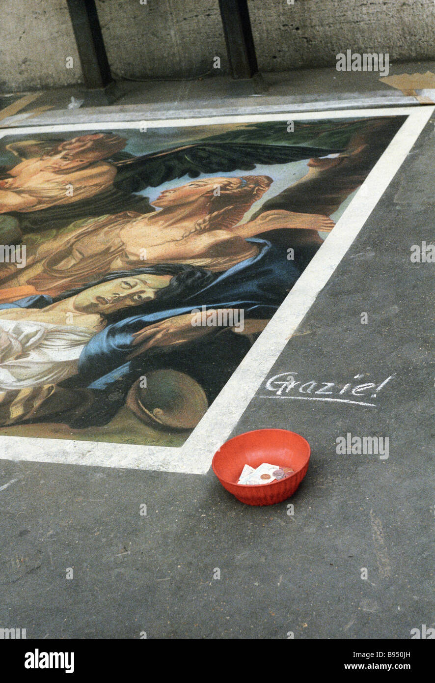 An alms bowl near a picture in a Rome street Stock Photo - Alamy