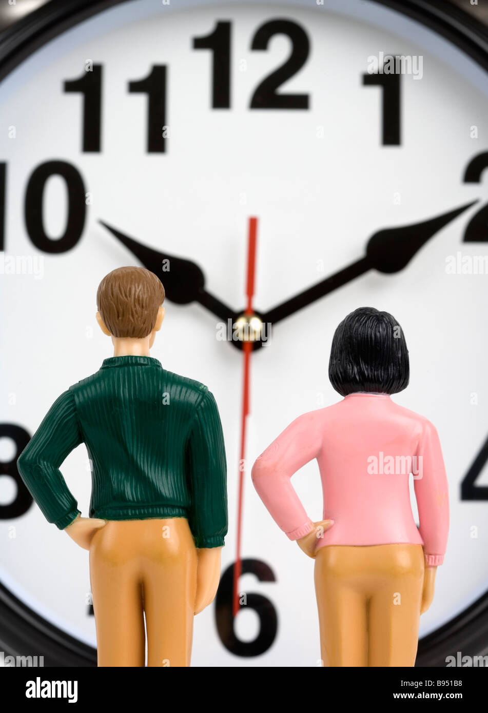 Couple figurines look at a clock hi-res stock photography and images ...