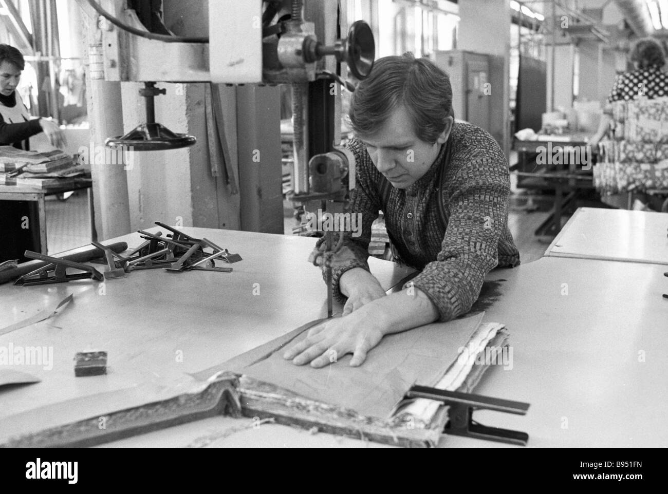 A cutting room worker shapes the fabric Kosmos dewing production ...