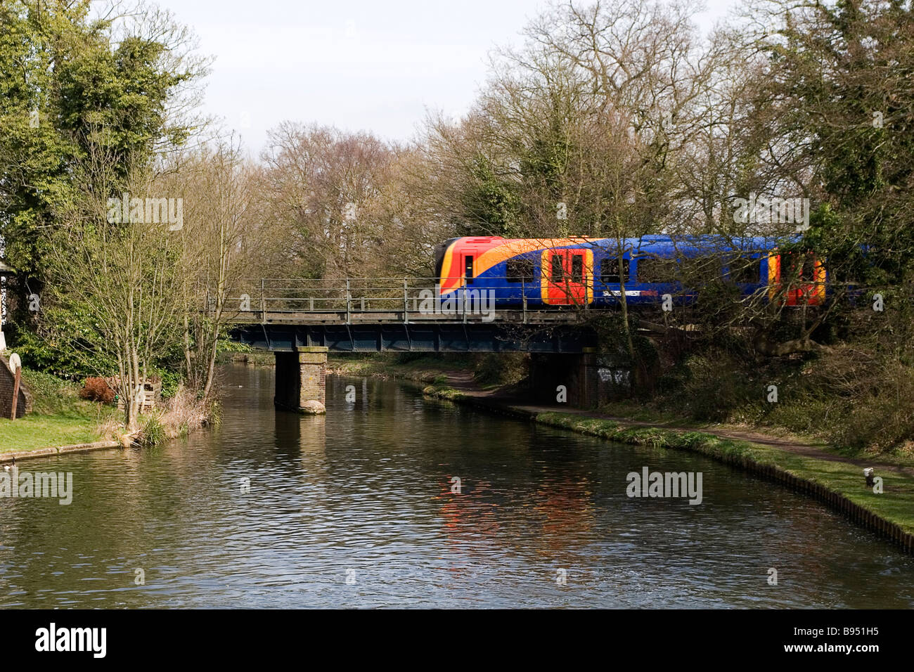 Train crossing the wey navigation canal at Coxes Lock, Addlestone Stock ...