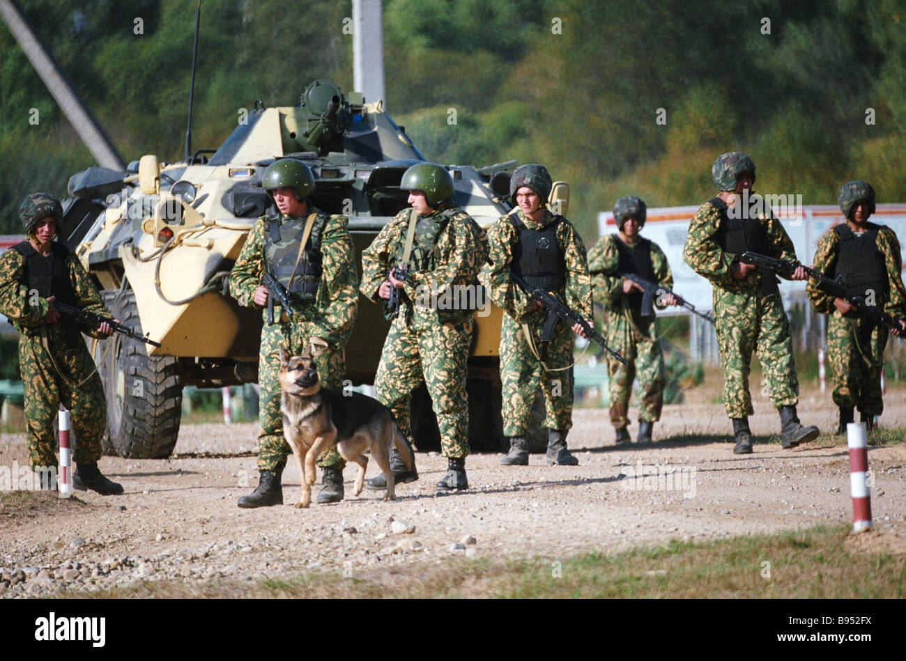 An engineering reconnaissance team searching for explosive devices in a ...