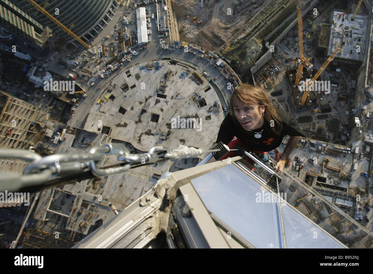 An urban climber Alain Robert nicknamed Spiderman climbing on top the ...