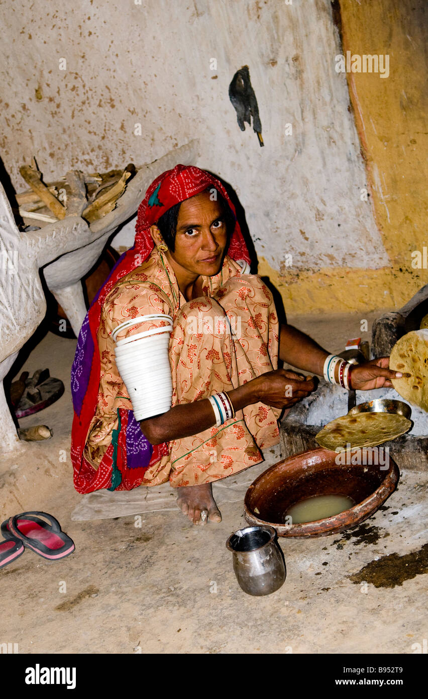 Cooking in her traditional home in a remote village in the desert ...