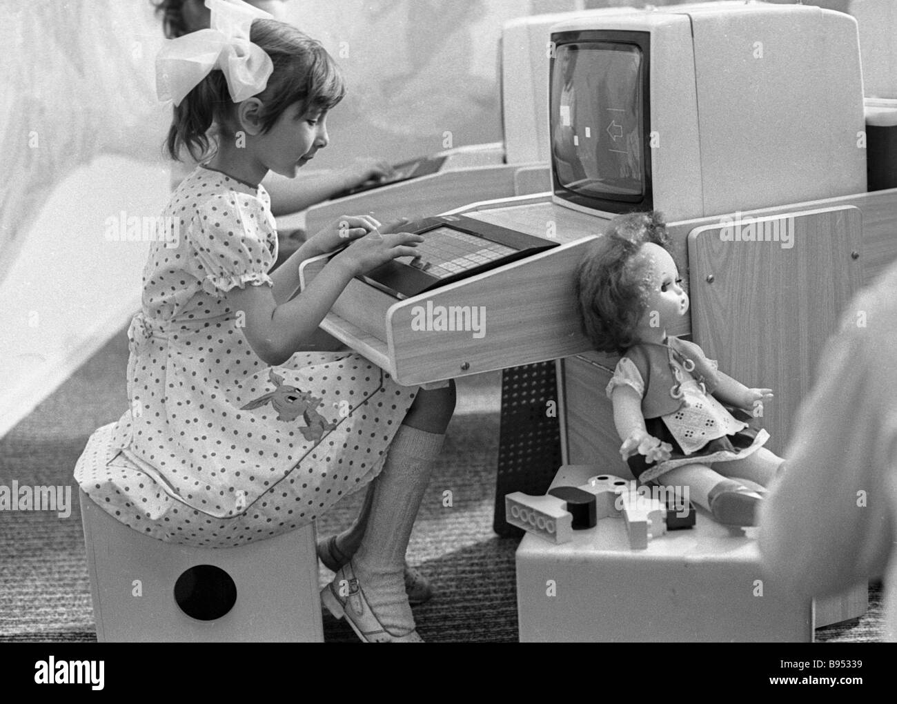 A kindergarten girl learns to use computer in a special computer class ...