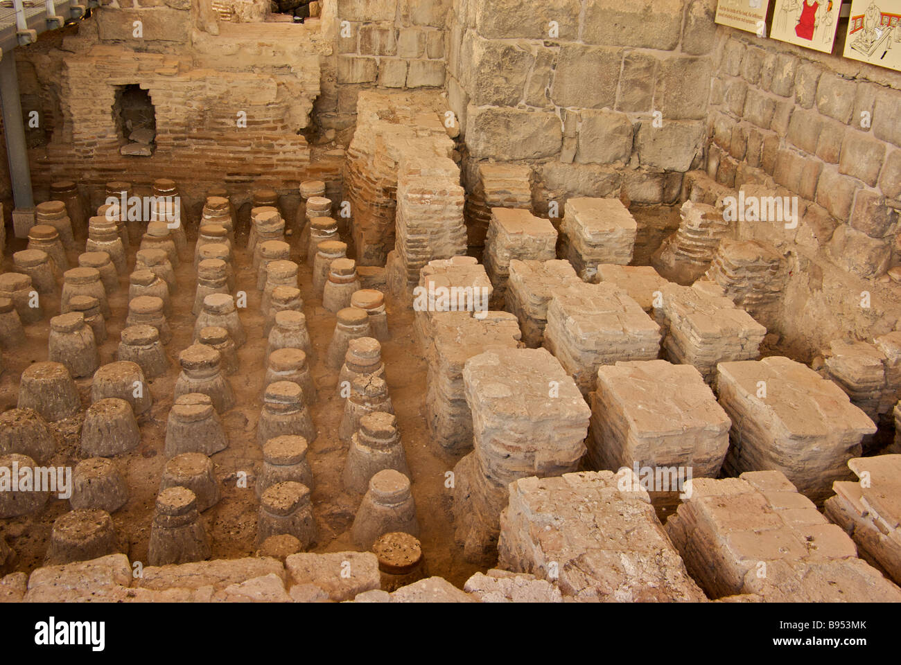 Low masonry support columns for floor with oven heat passages to warm ...