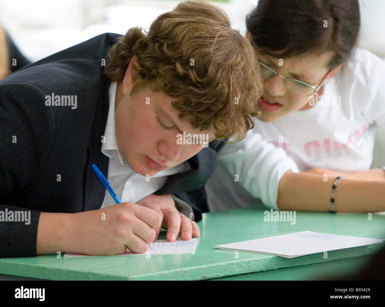 Senior students taking written exam in literature at one of Kurgan ...