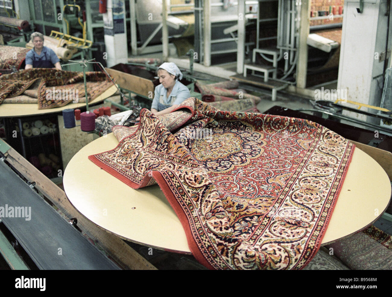 Finishing the side edges of ready made rugs at the Lyubertsy carpet ...