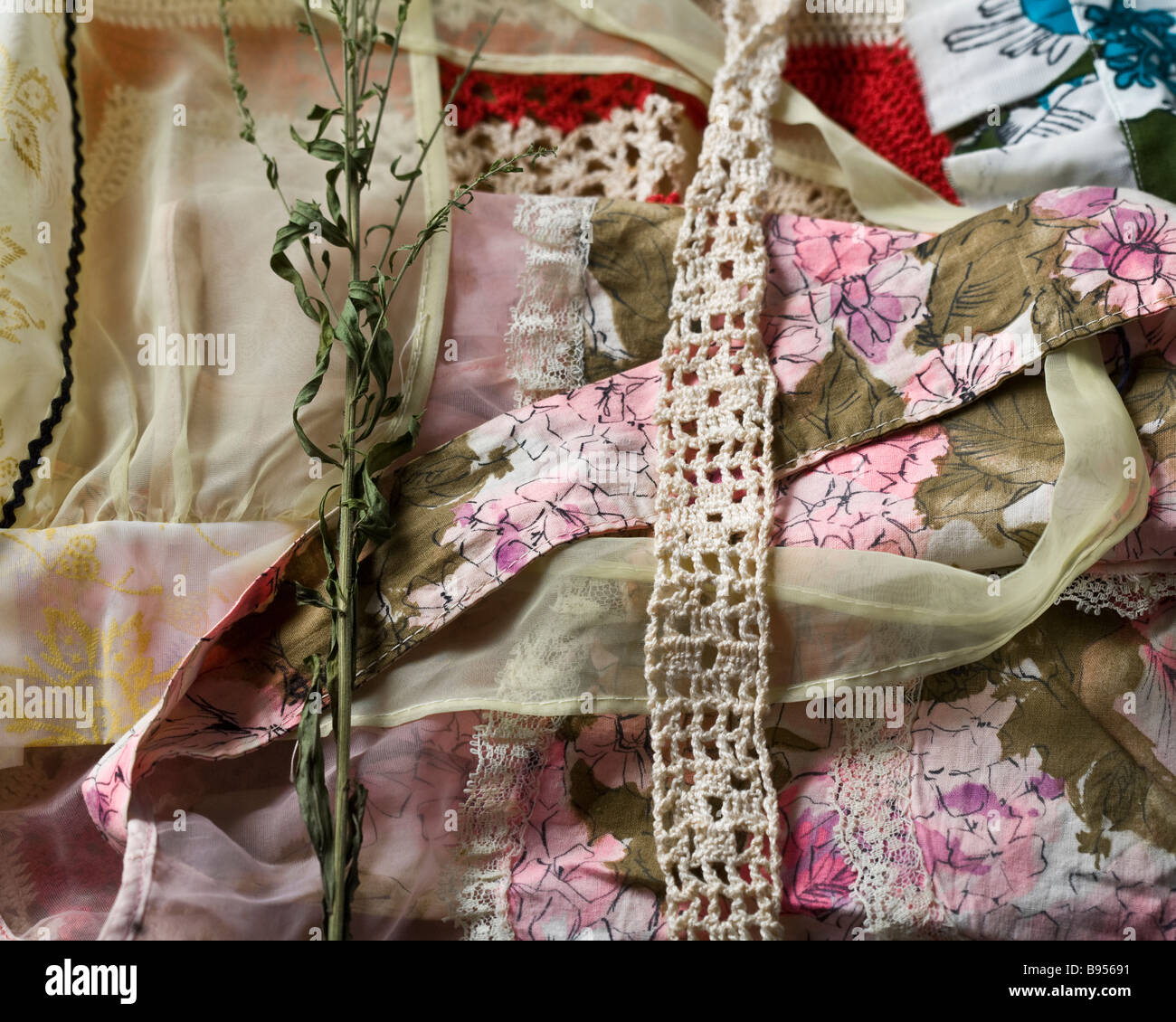 vintage fabric aprons with a dried flower stem Stock Photo - Alamy
