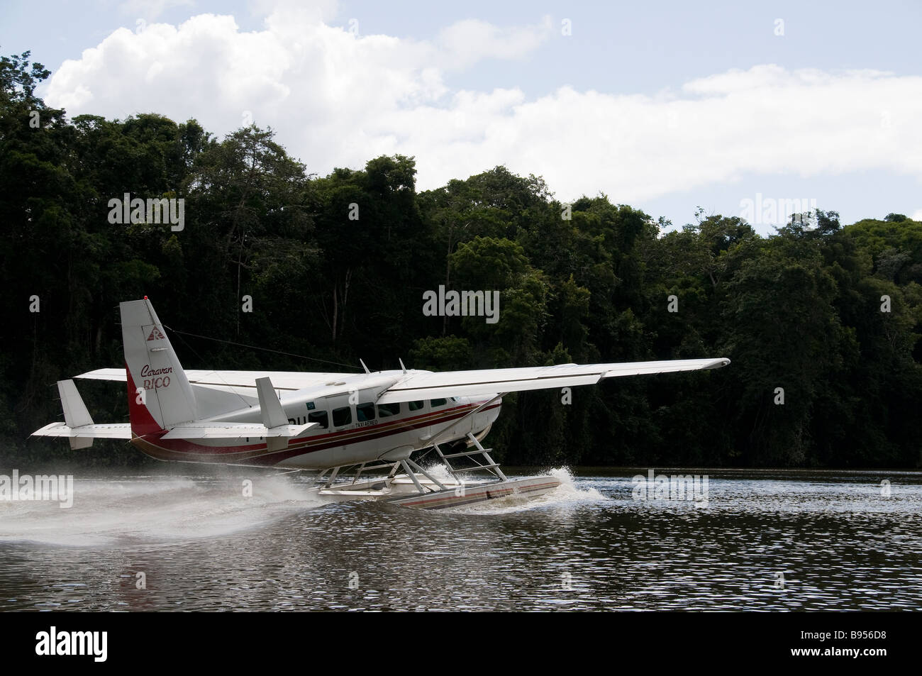 A Caravan float plane takes off from a small blackwater tributary that ...