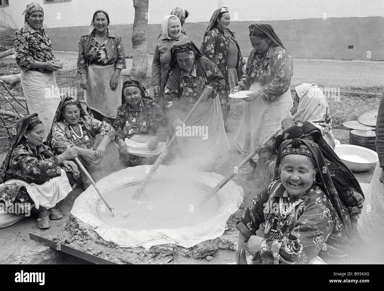 Uzbek women cooking the national dish sumalak in a cauldron in ...