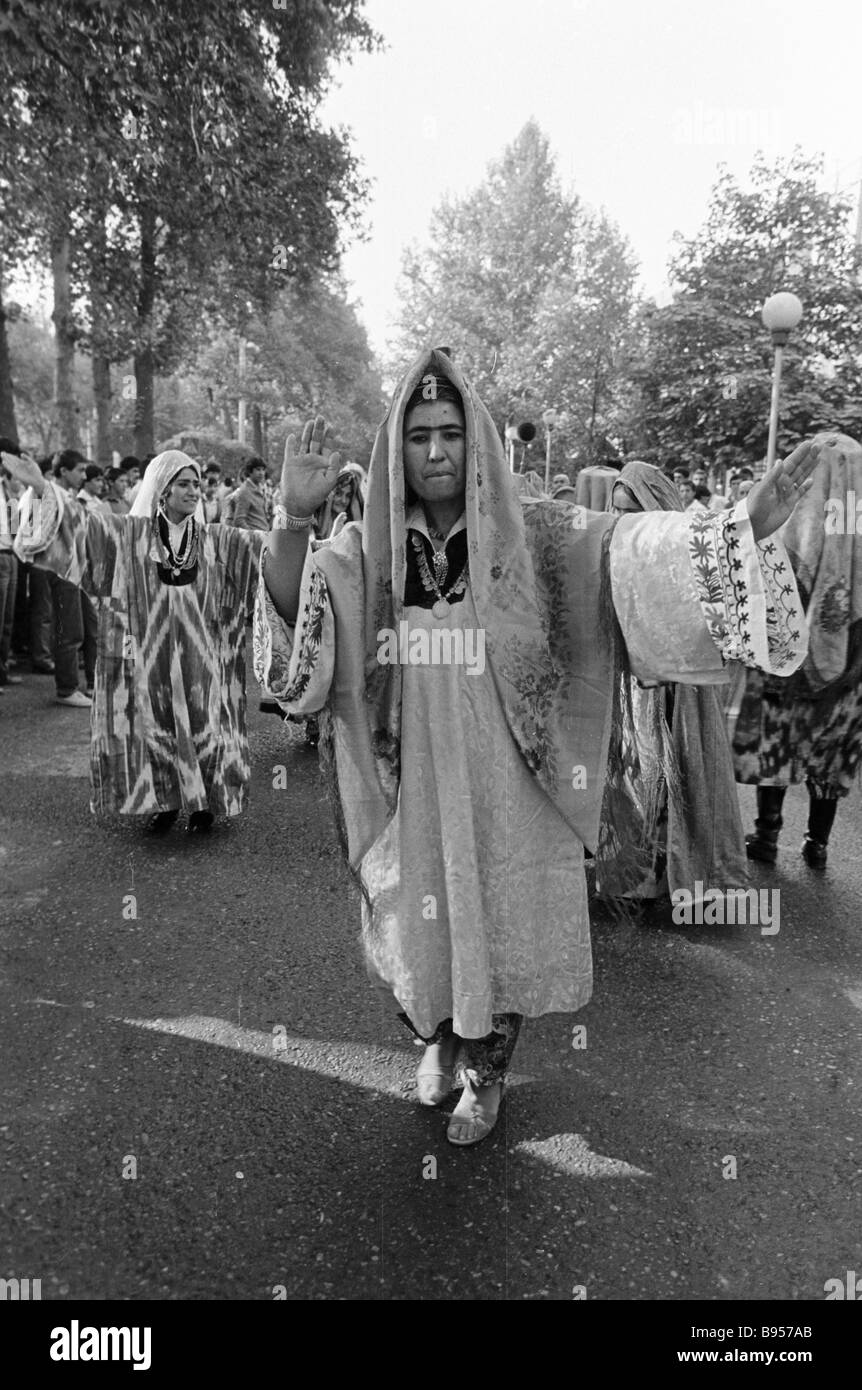 Women in national Tajik clothes dancing in the streets of Dushanbe ...